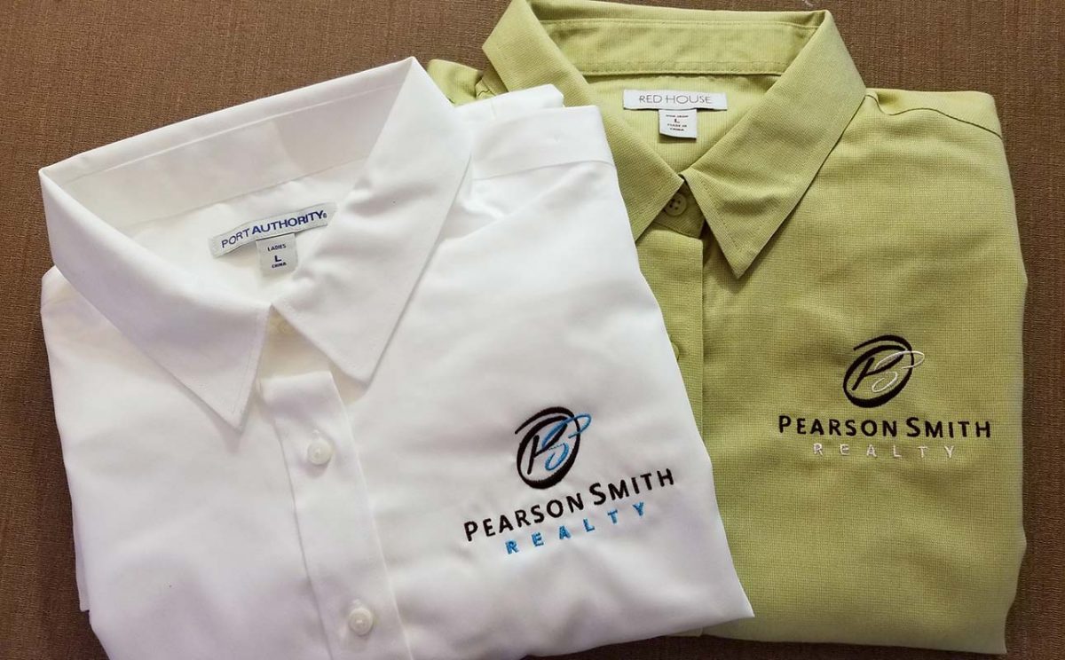 Two shirts with Pearson Smith Realty logo embroidered on left chest ...